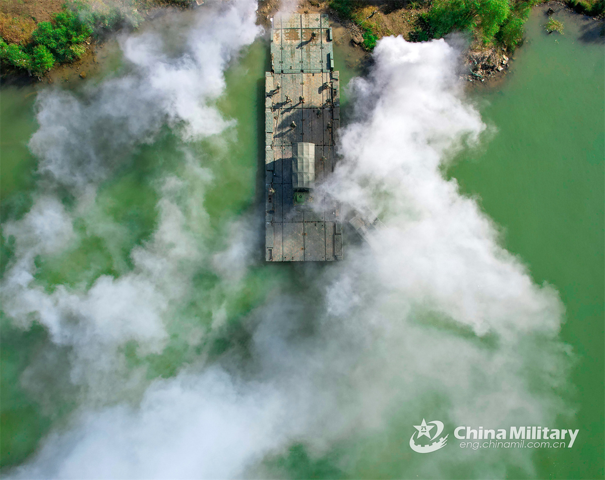 Pontoon troops ferry military vehicles across river