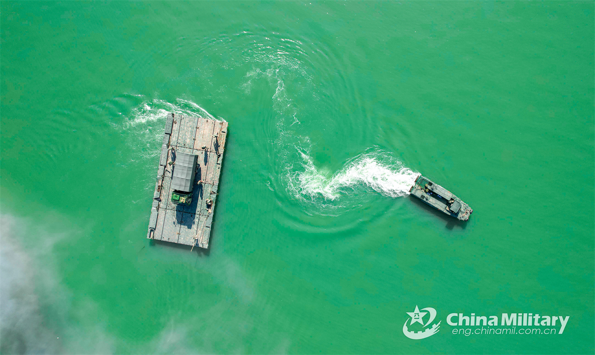 Pontoon troops ferry military vehicles across river